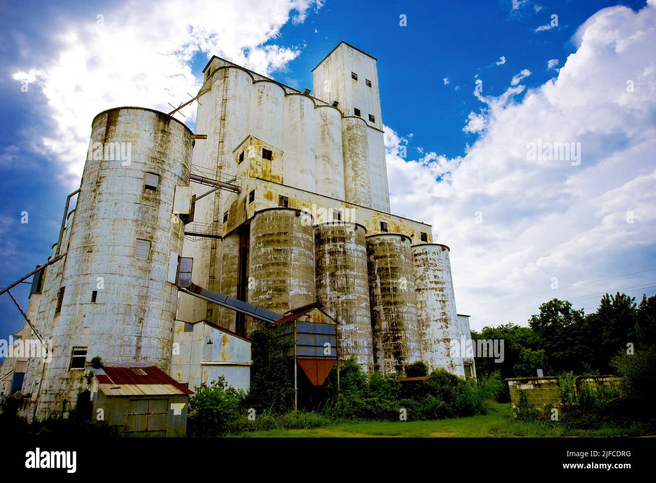 Dingy, rust stained white paint gleaming against a stormy sky, an ...