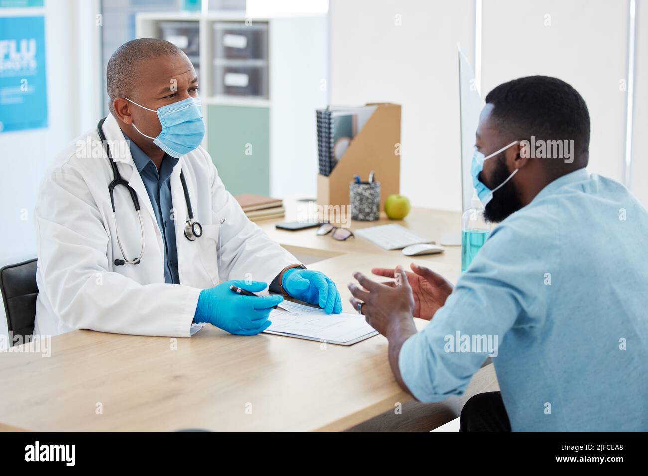 African american doctor talking a patient about his results. Patient in ...