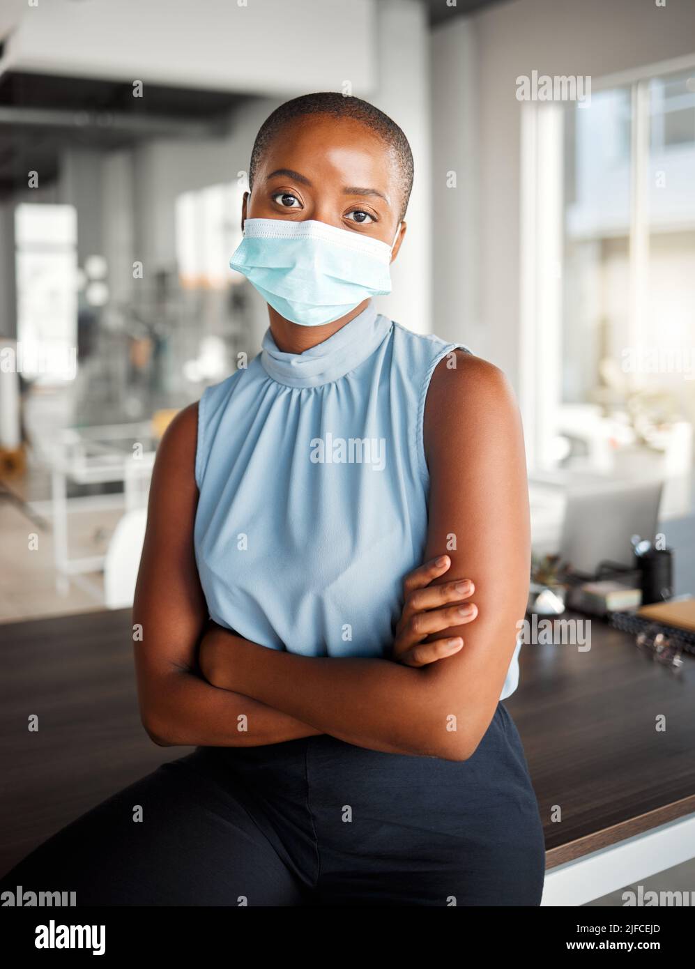 Young african american businesswoman standing with her arms crossed and ...