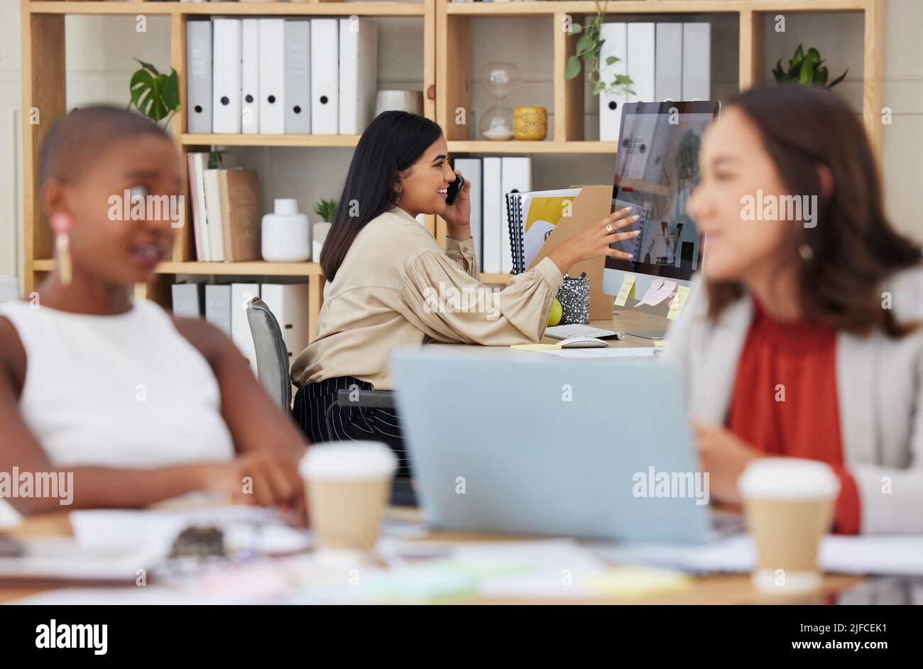 Serious ambitious indian business woman using cellphone to talk to ...
