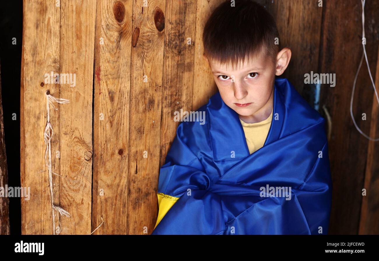 war russia against Ukraine. crying Ukrainian boy with the flag of ...