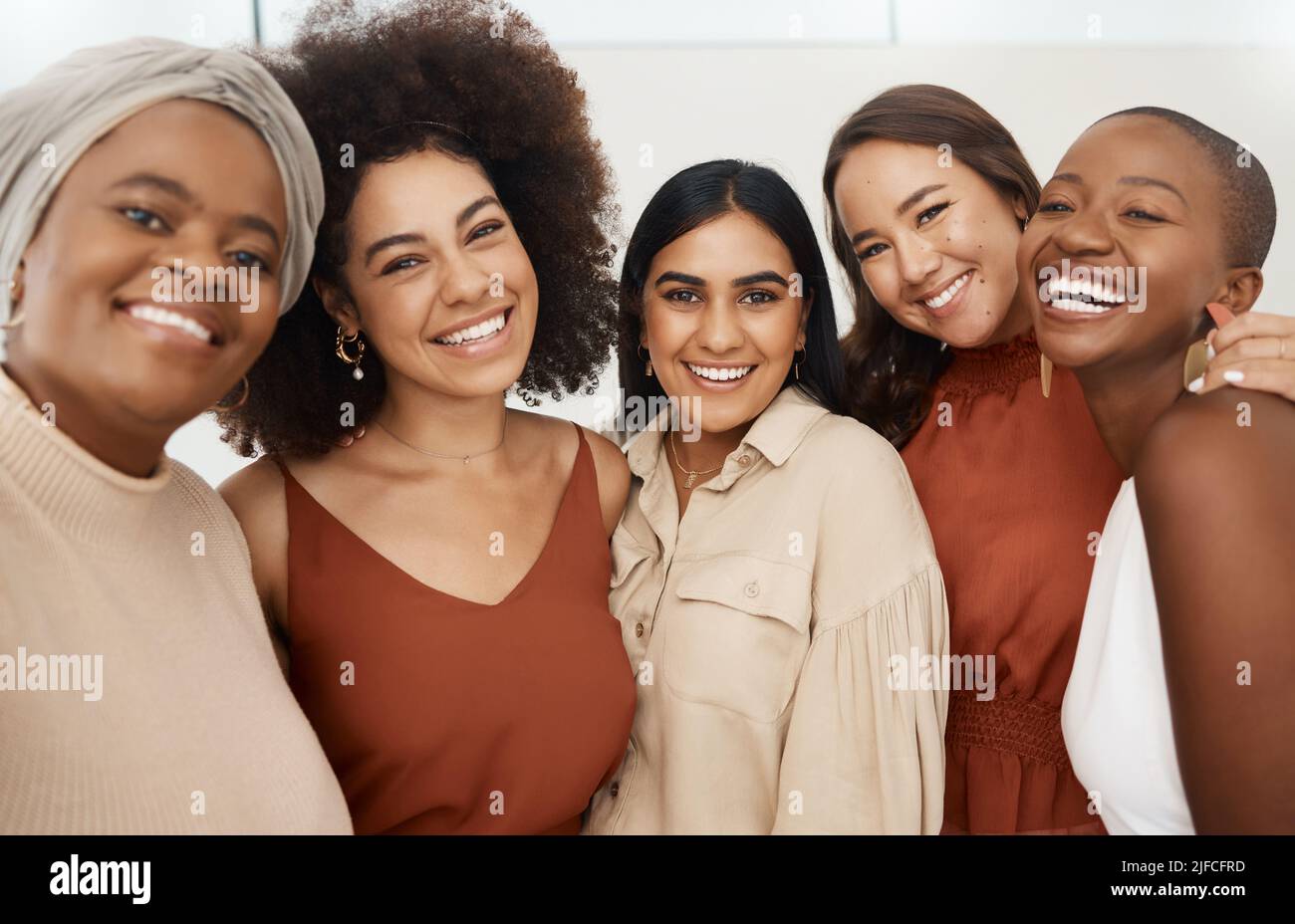 Happy diverse group of young female friends taking a selfie together ...