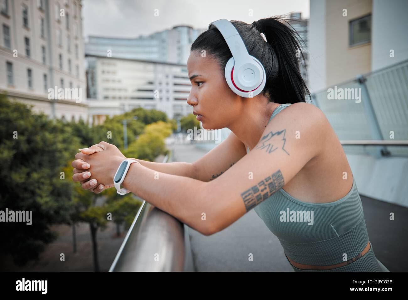 Young serious mixed race hispanic female athlete looking thoughtful ...