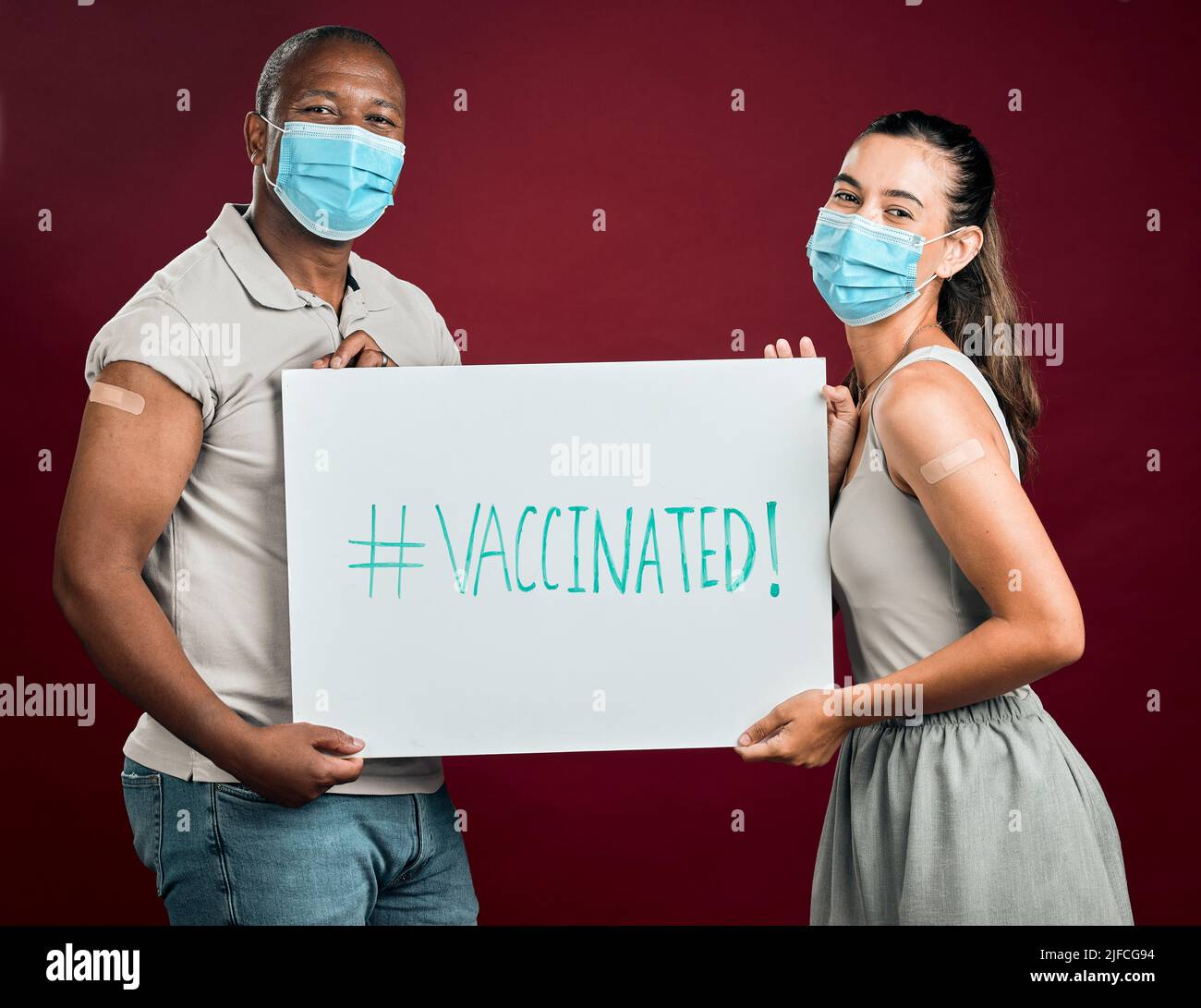 Covid vaccinated African american man and mixed race woman showing and ...