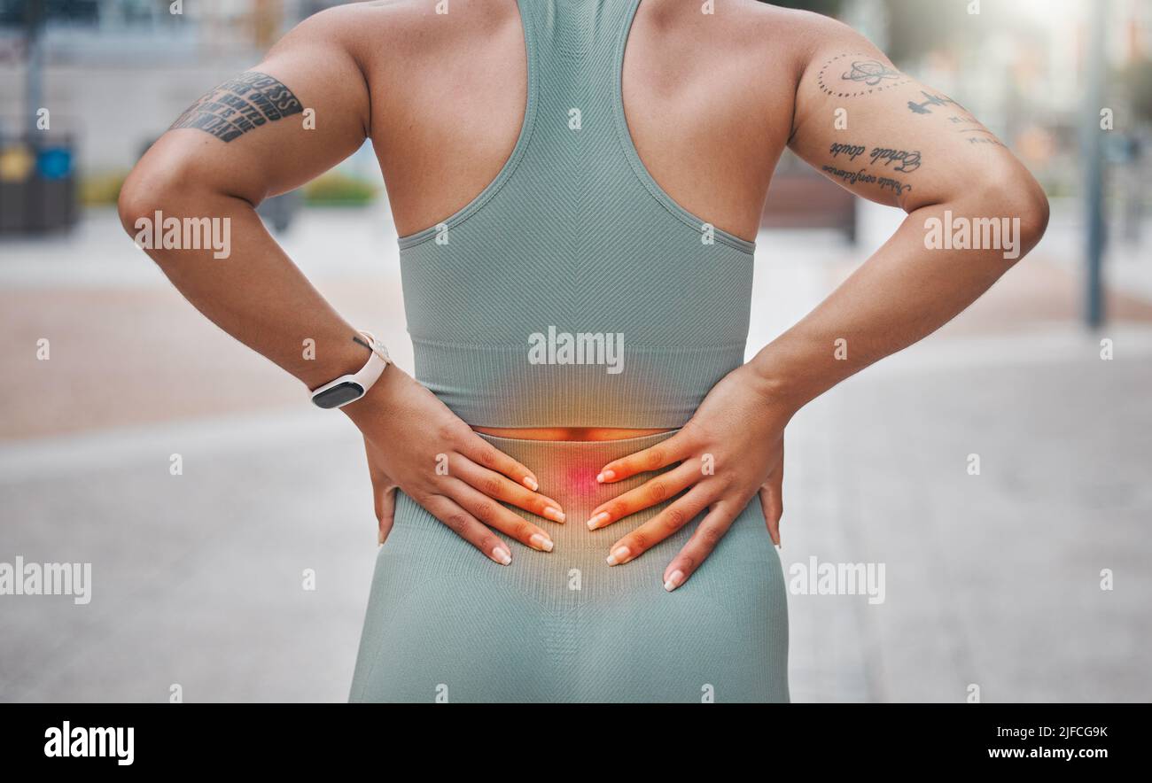 Closeup shot of a young african american woman suffering with back pain ...