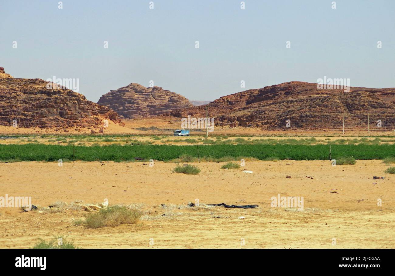 truck running fast on an isolated road in the middle of the desert and ...