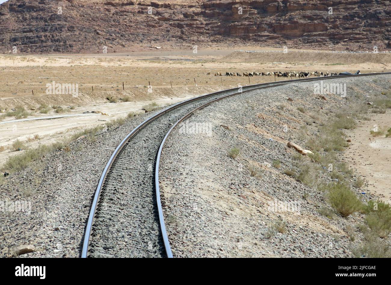 Curve of the railway tracks without train in the middle of the desert ...