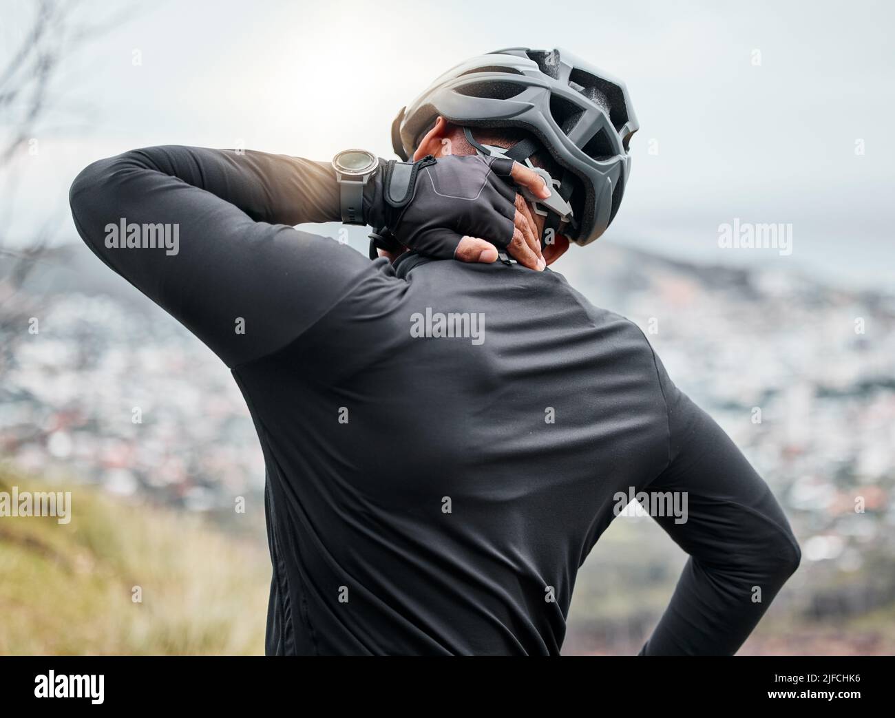 Closeup of a man suffering an injury while out cycling outside. Unknown ...