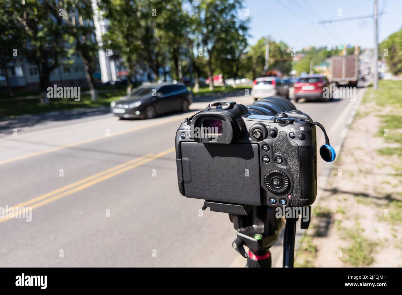 modern black professional mirrorless camera on tripod or monopod ...