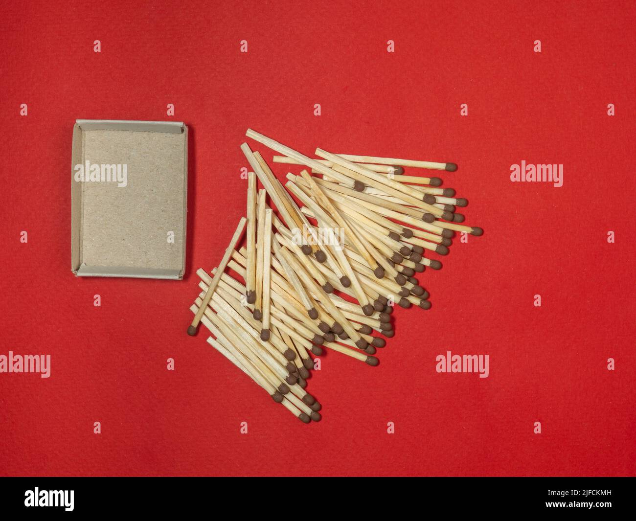 Matchsticks on a red background. Safe handling of fire. Fire dangers ...
