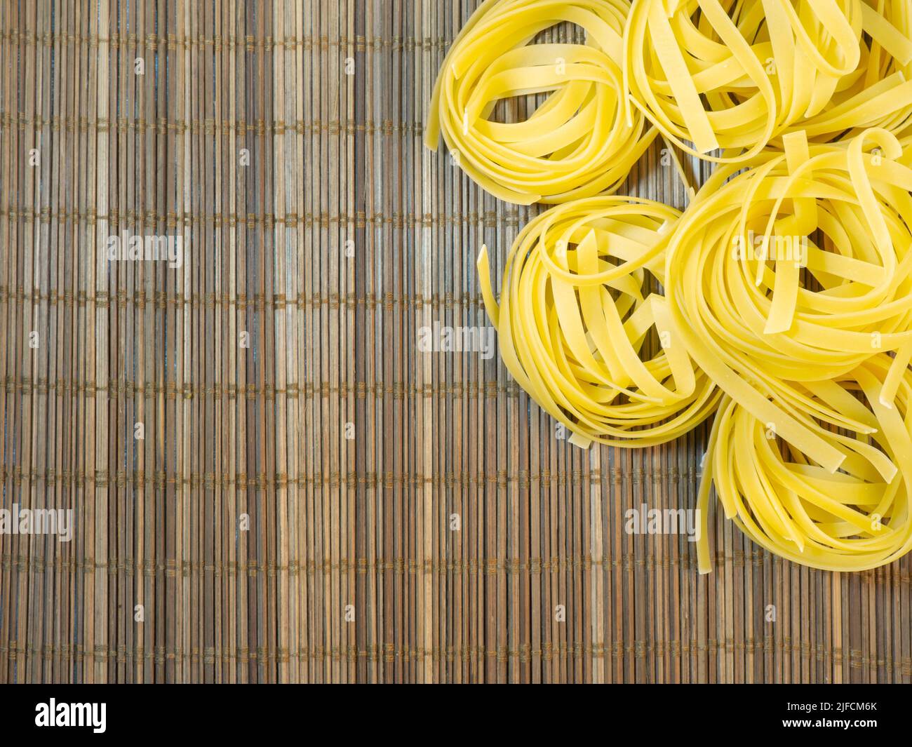 Pasta nests on a wicker background. Type of noodle. Unprepared product ...