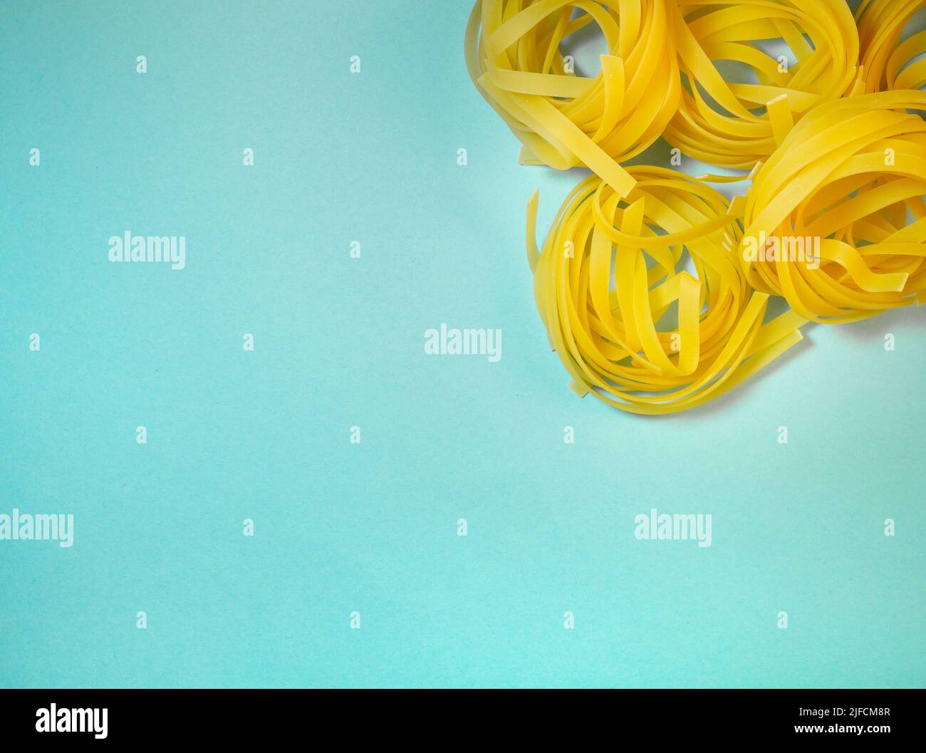 Pasta nests on a blue background. Noodle type. Culinary background ...