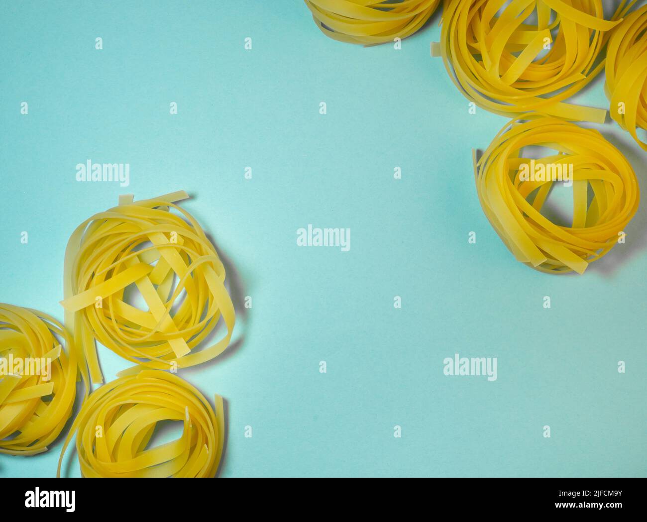 Pasta nest on a blue background. Noodle type. Culinary background ...