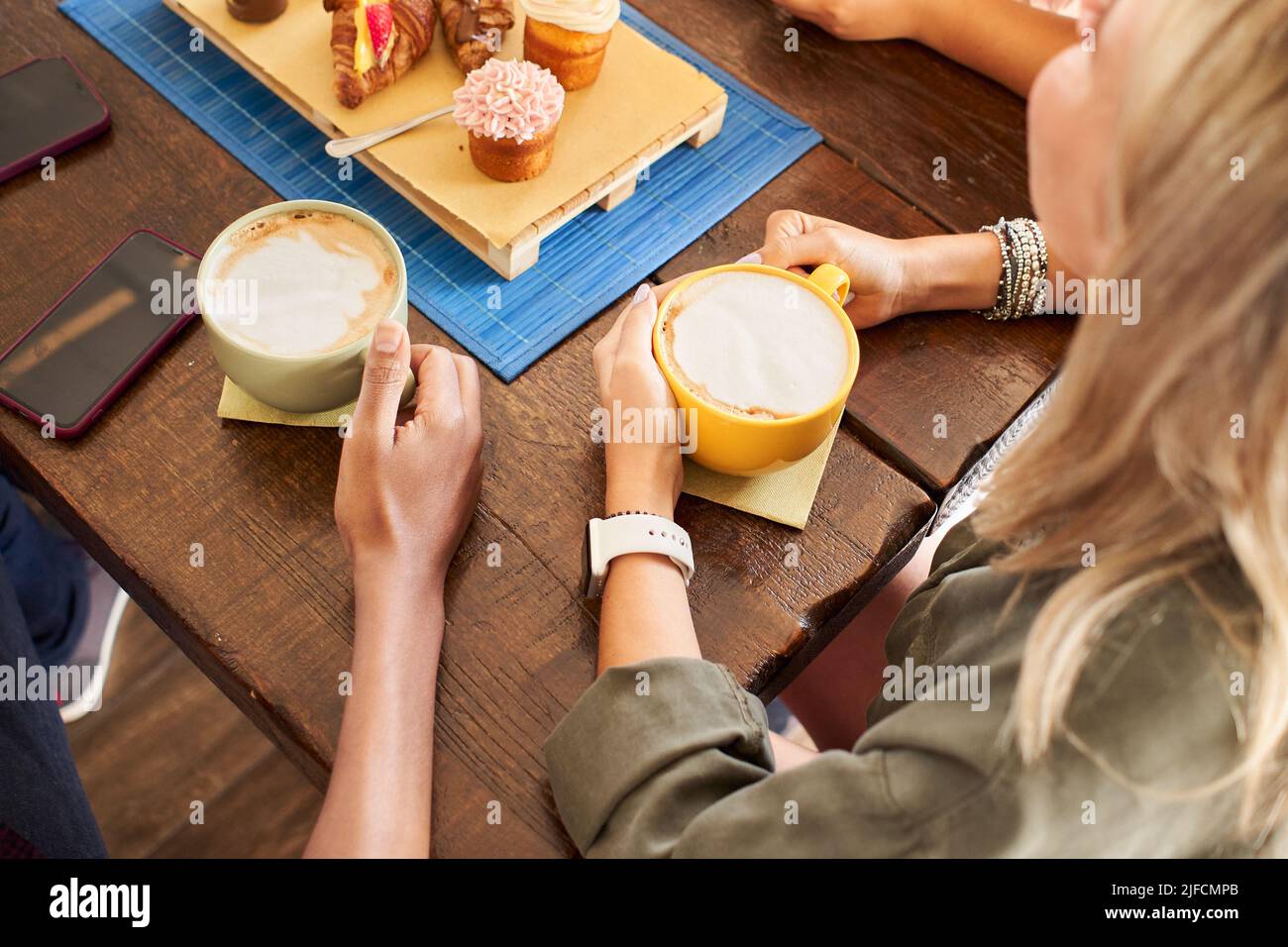 Unrecognizable Friends in the terrace bar breakfast at morning ...
