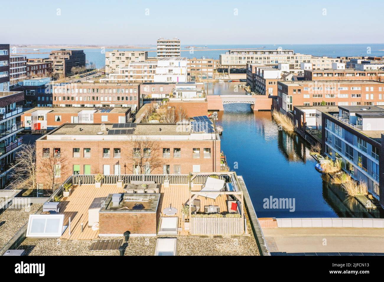 Panoramic view of the city, high-rise and brick houses, water surface ...