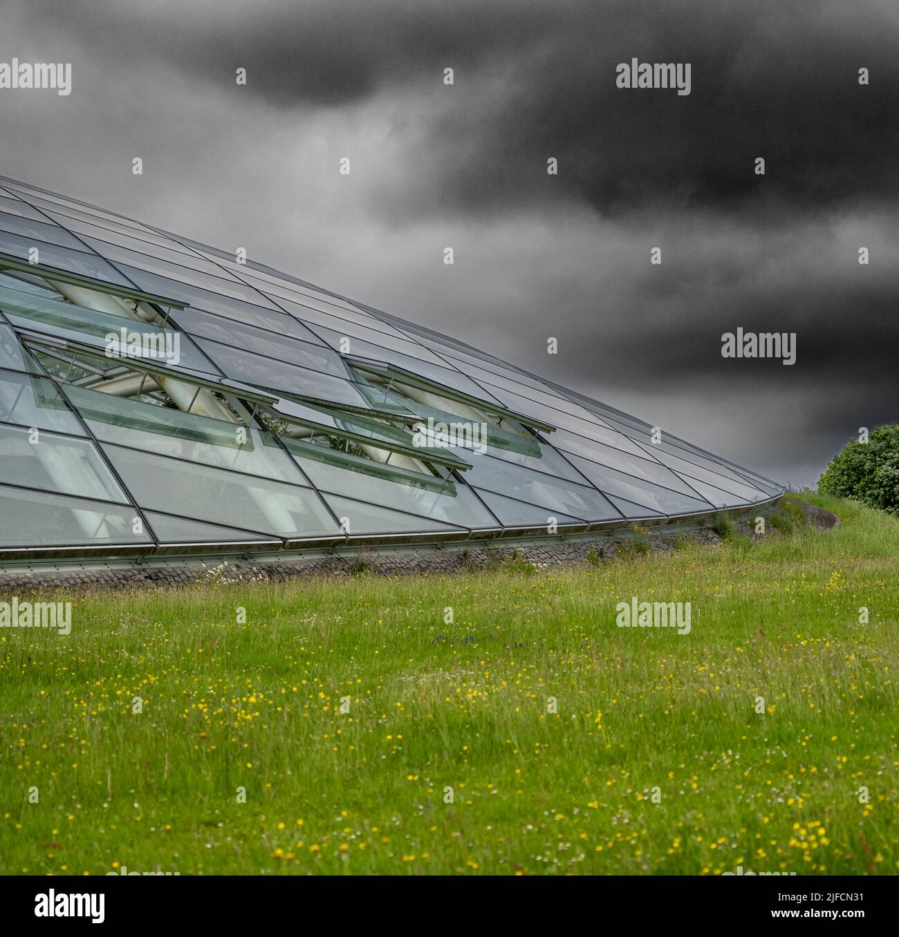 Futuristic conservatory dome of glass panels in steel joists, set into ...