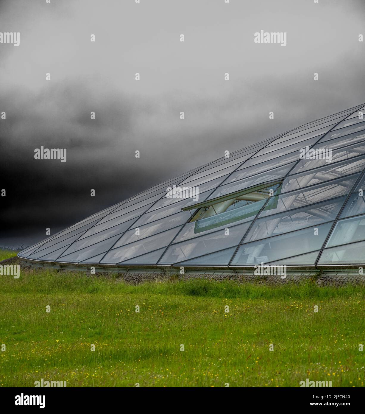 Futuristic conservatory dome of glass panels in steel joists, set into ...