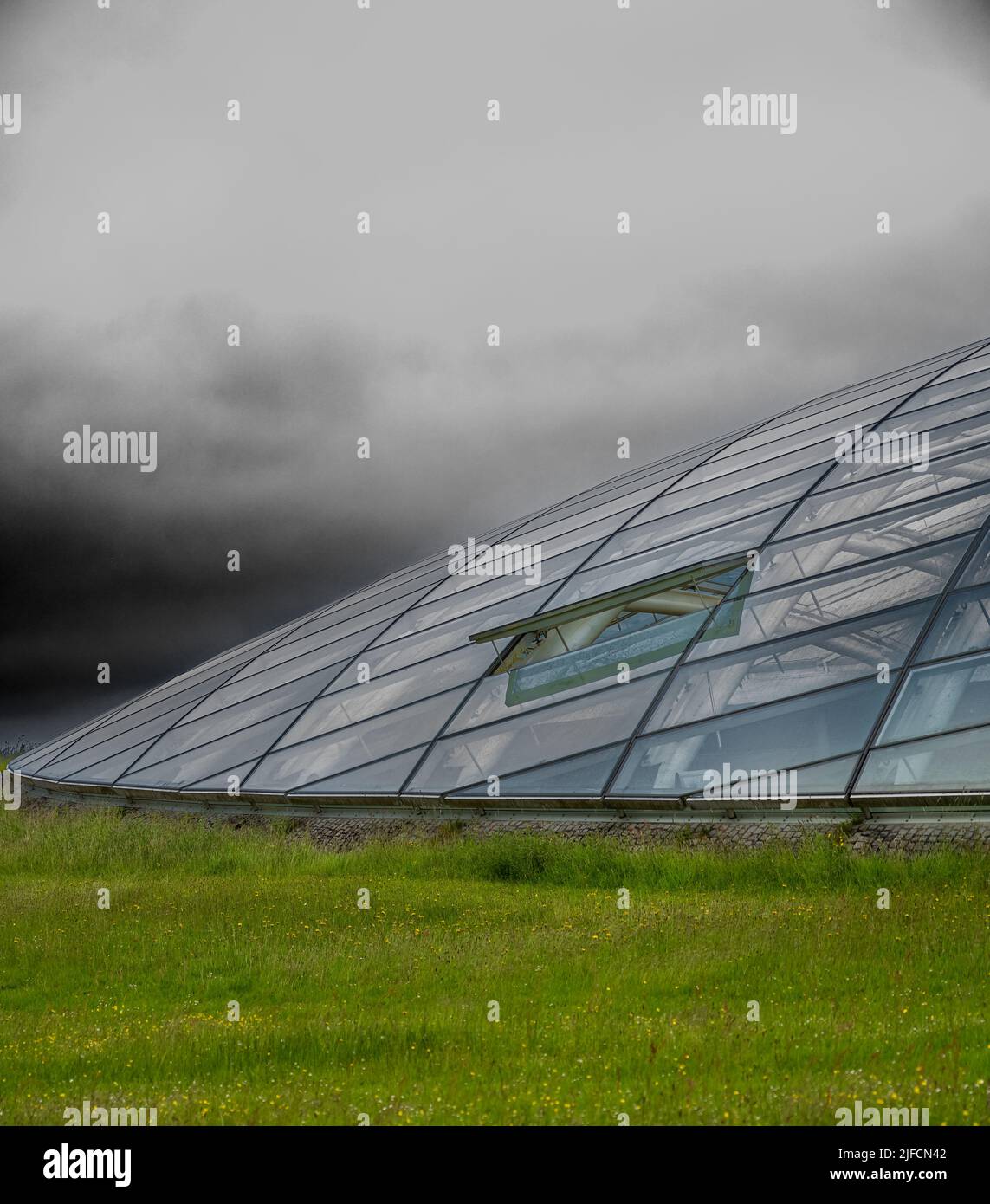 Futuristic conservatory dome of glass panels in steel joists, set into ...