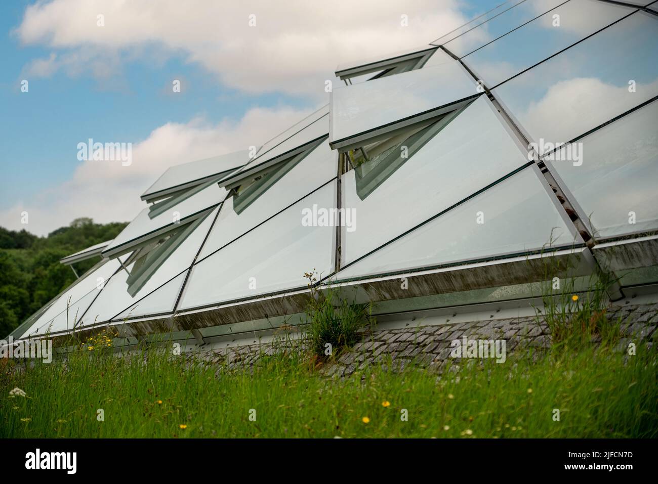 Futuristic conservatory dome of glass panels in steel joists, set into ...