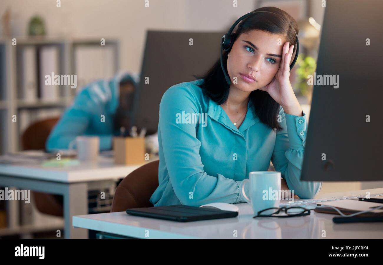 One stressed young caucasian call centre telemarketing agent looking ...