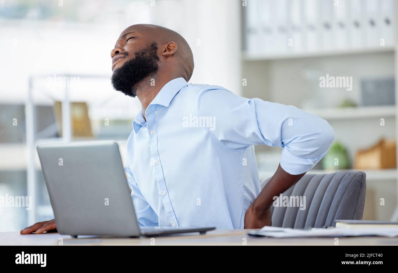 Unhappy african american businessman suffering from bad back pain in an ...