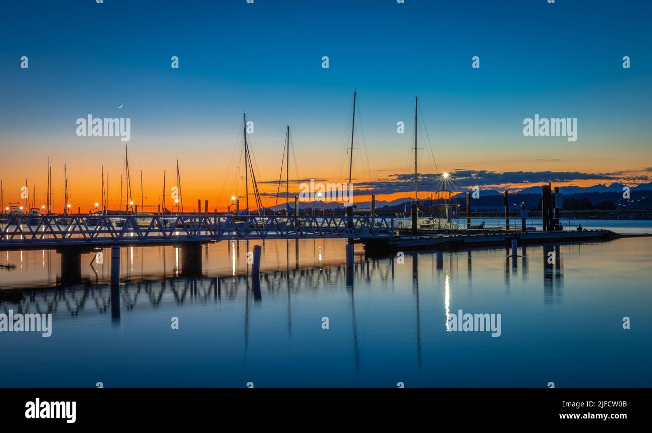 Beautiful sundown at the yacht harbor with pier. Summer sunset at the ...
