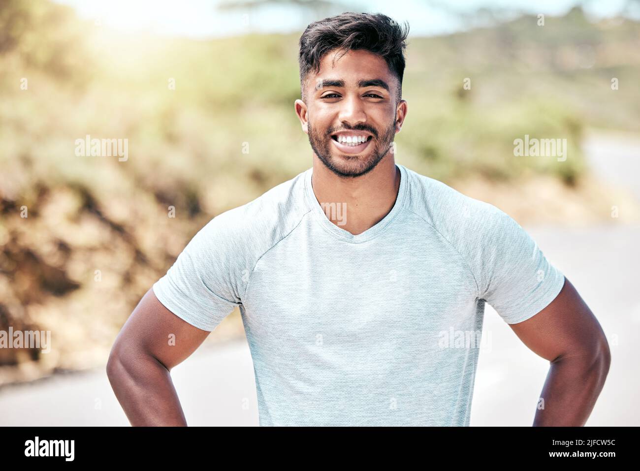 Portrait of happy young mixed race man getting ready to workout. Young ...