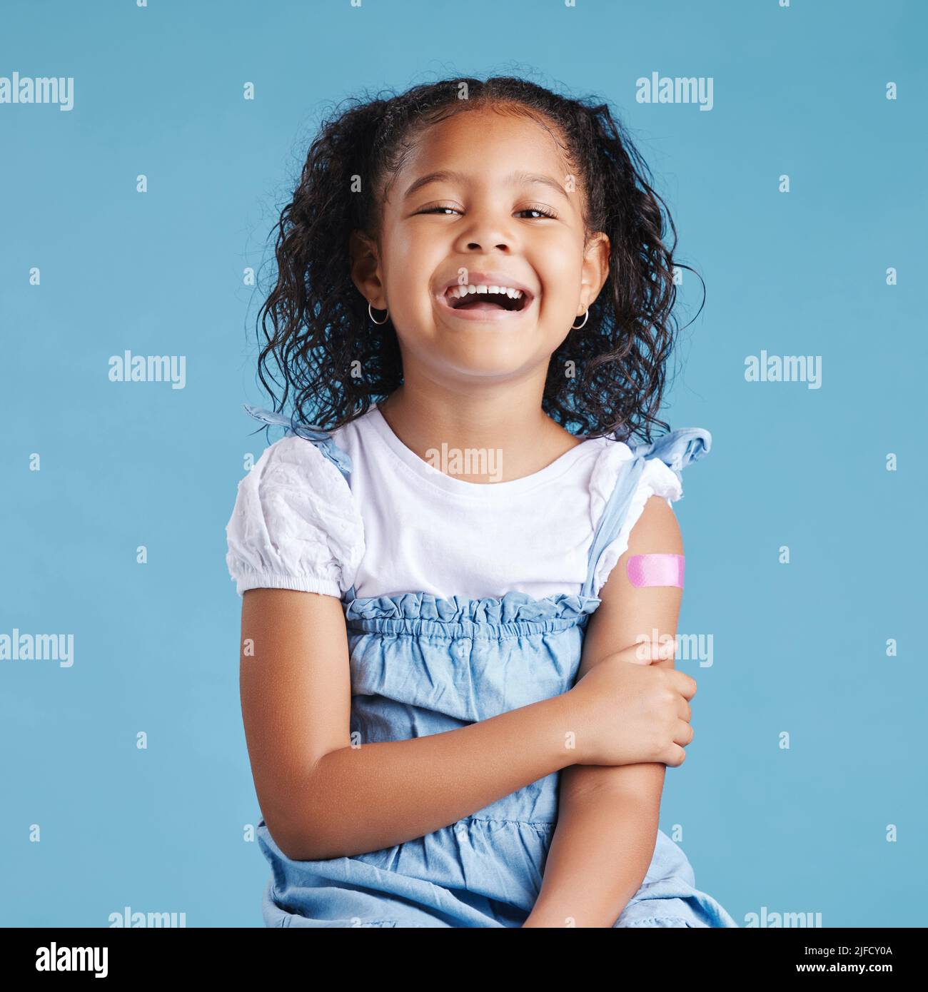 Happy vaccinated little girl kid showing arm with adhesive bandage ...