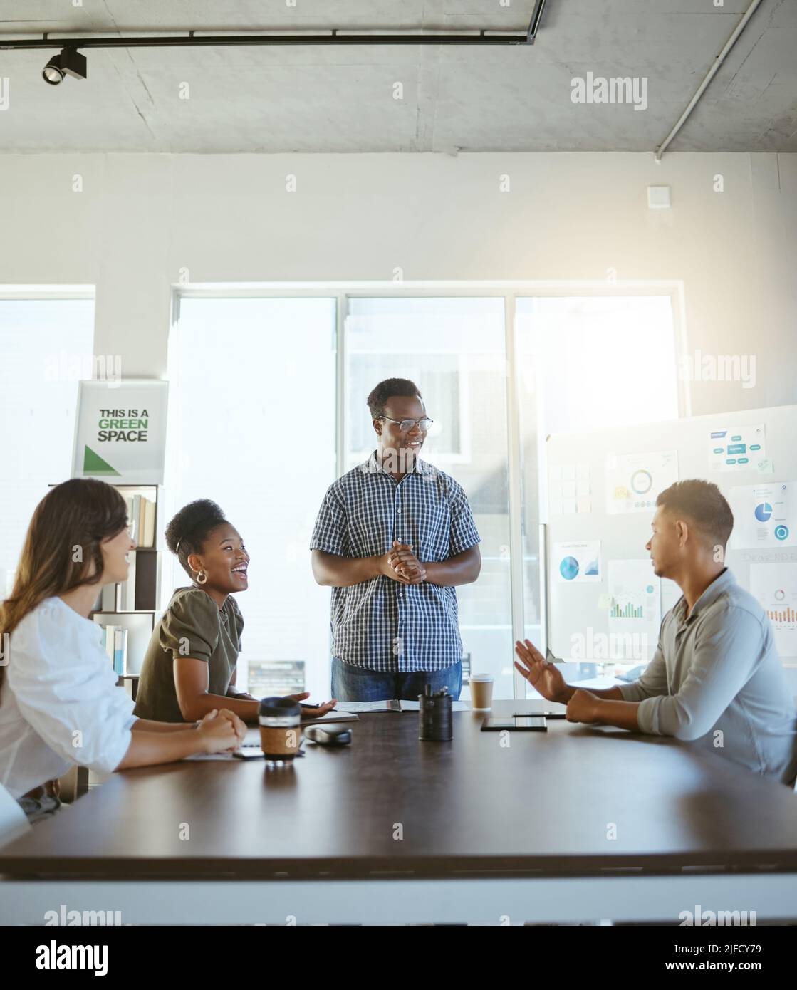 Group of cheerful diverse businesspeople having a meeting in an office ...