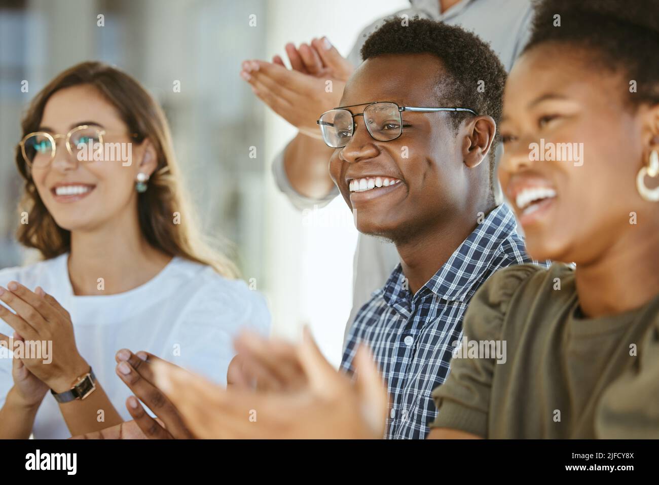 Group of joyful diverse businesspeople clapping hands in support during ...