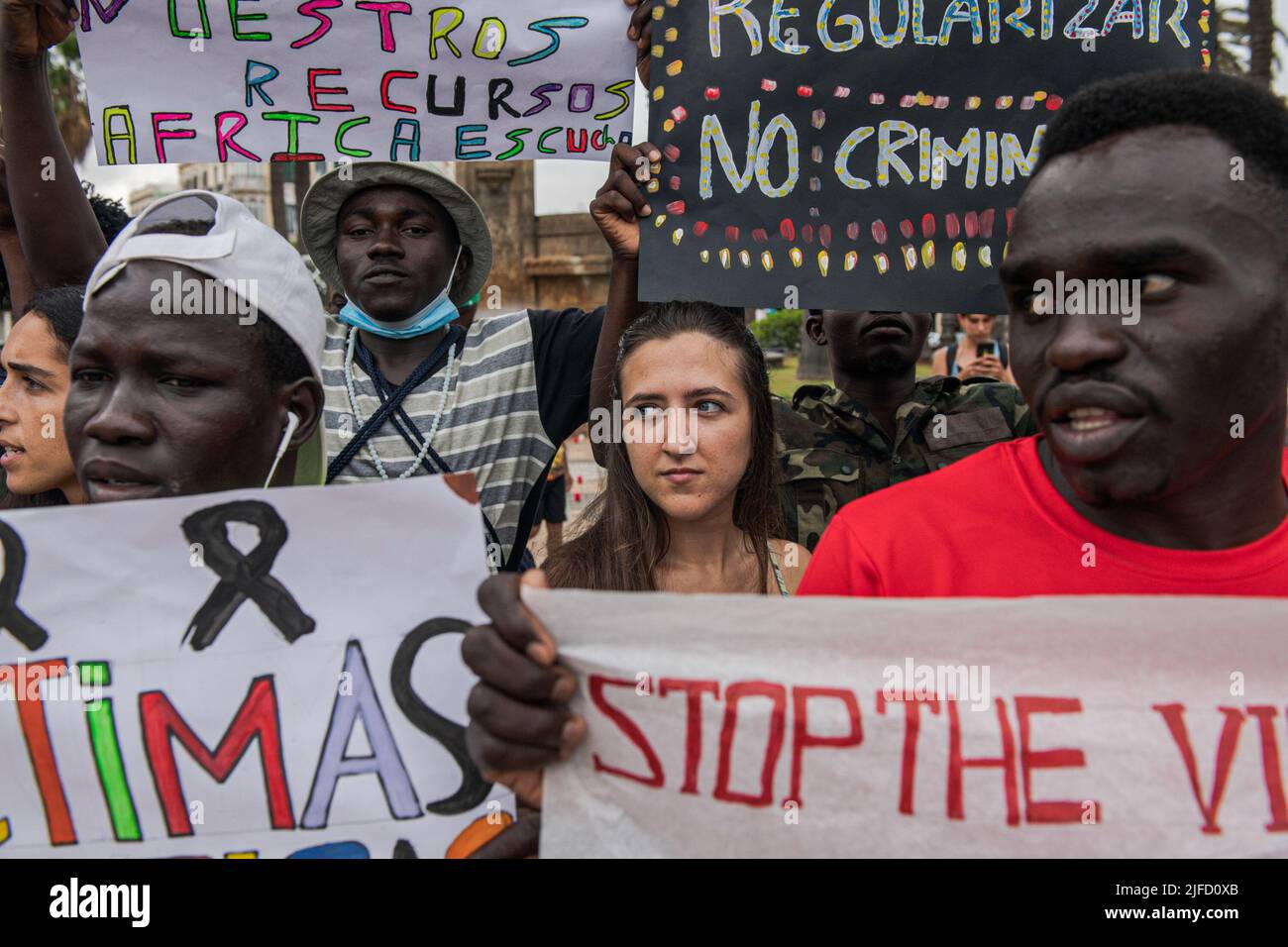 Melilla, Spain. 01st July, 2022. Protesters hold placards during the ...