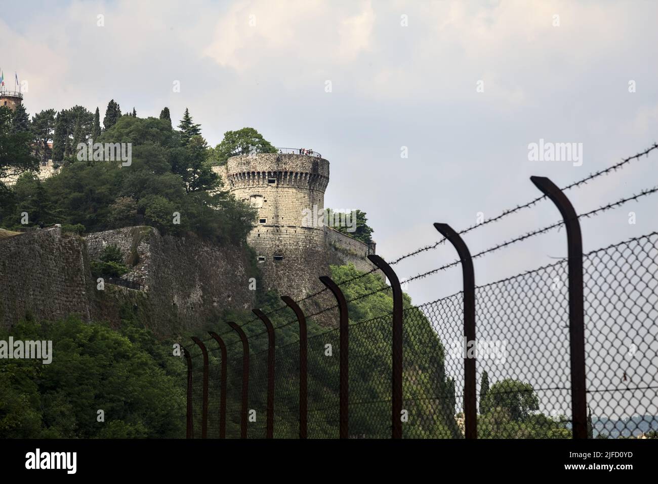 Old fortification on a cliff in a forest seen from the distance behind ...