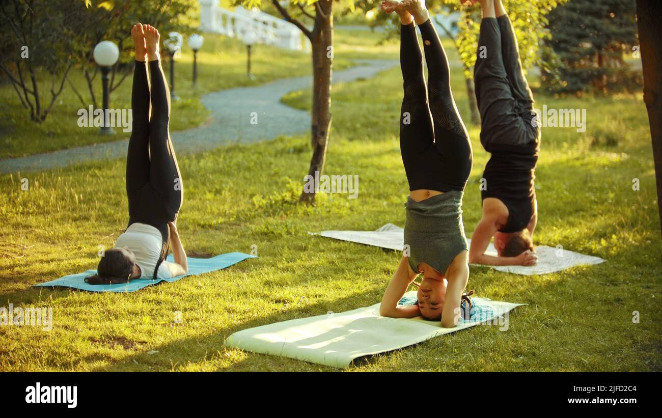 Man two women doing headstand hi-res stock photography and images - Alamy