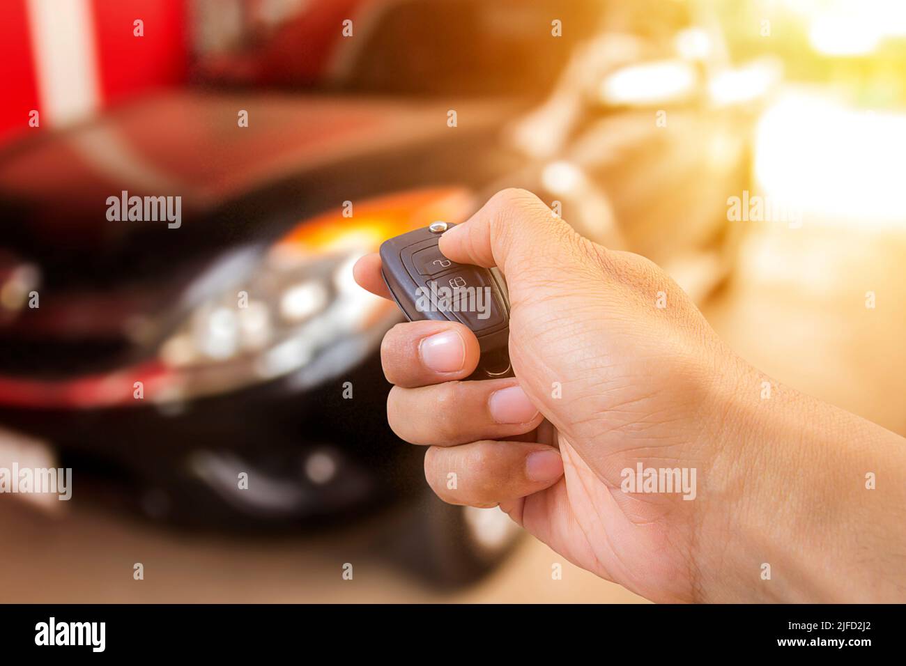 Men's hand presses on the remote control car alarm systems with ...