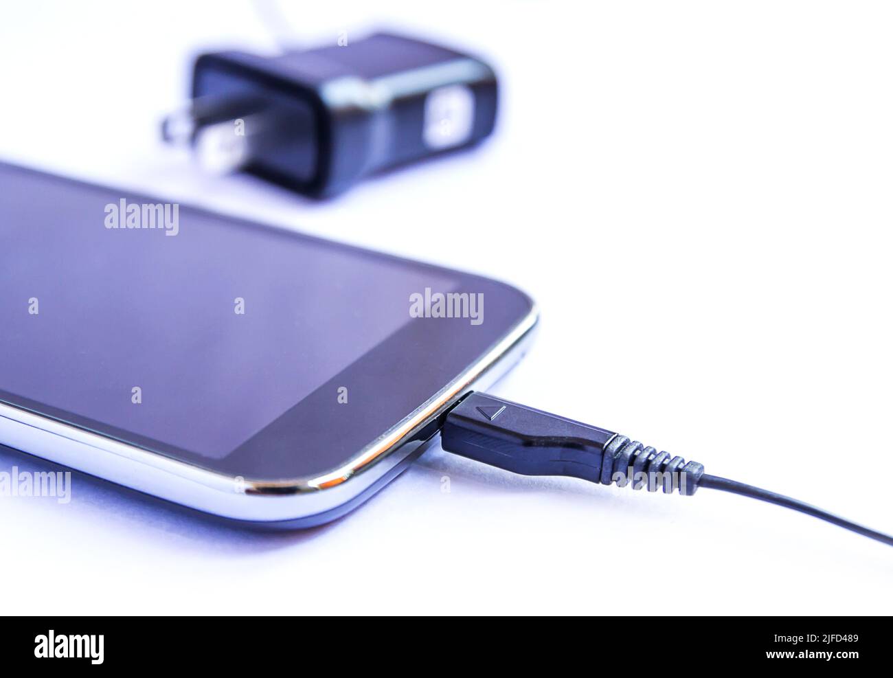 Close up black smartphone and USB cable on a white background Stock ...
