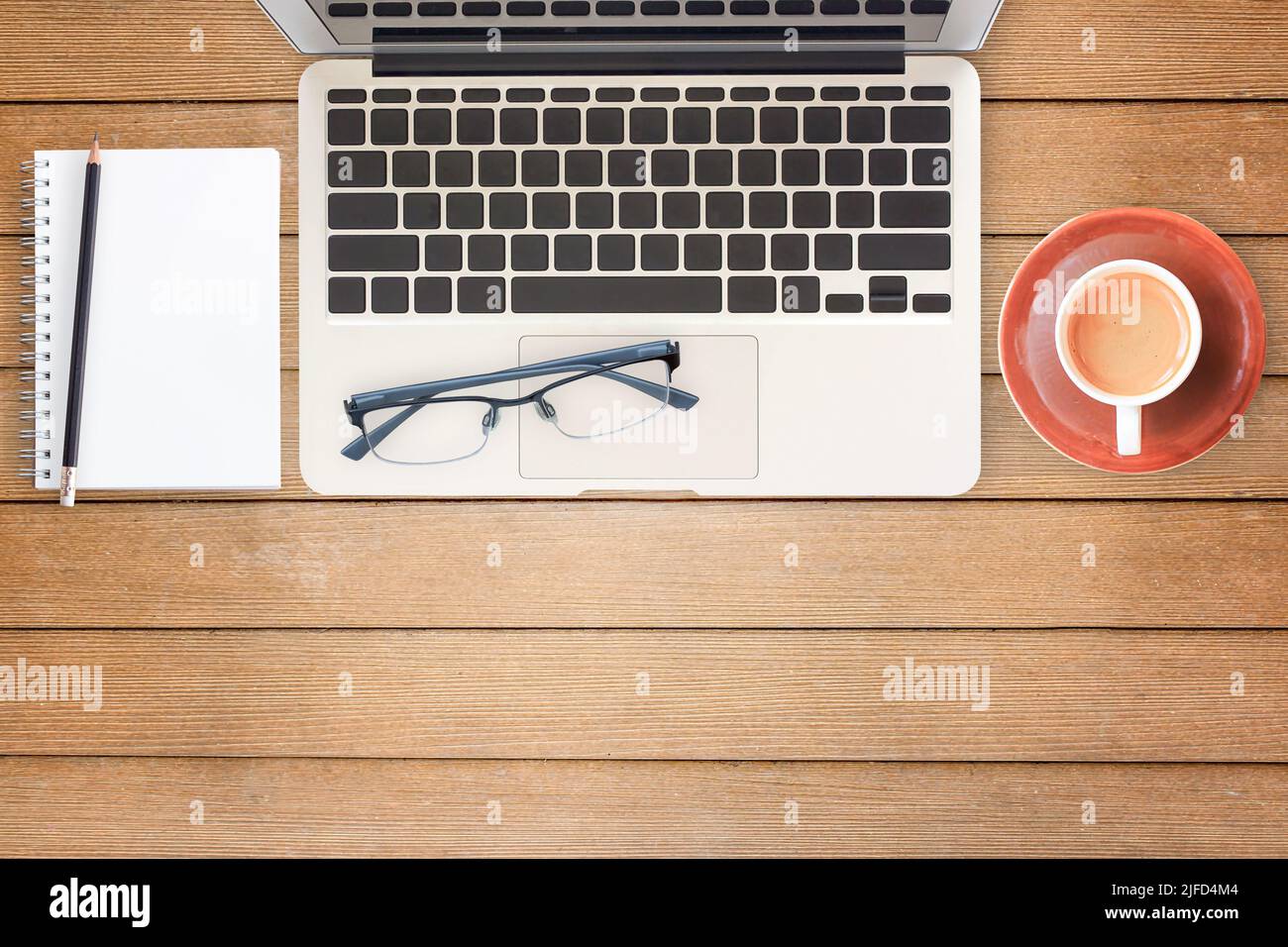 Office desk of laptop computer and cup of coffee with note pad top view ...