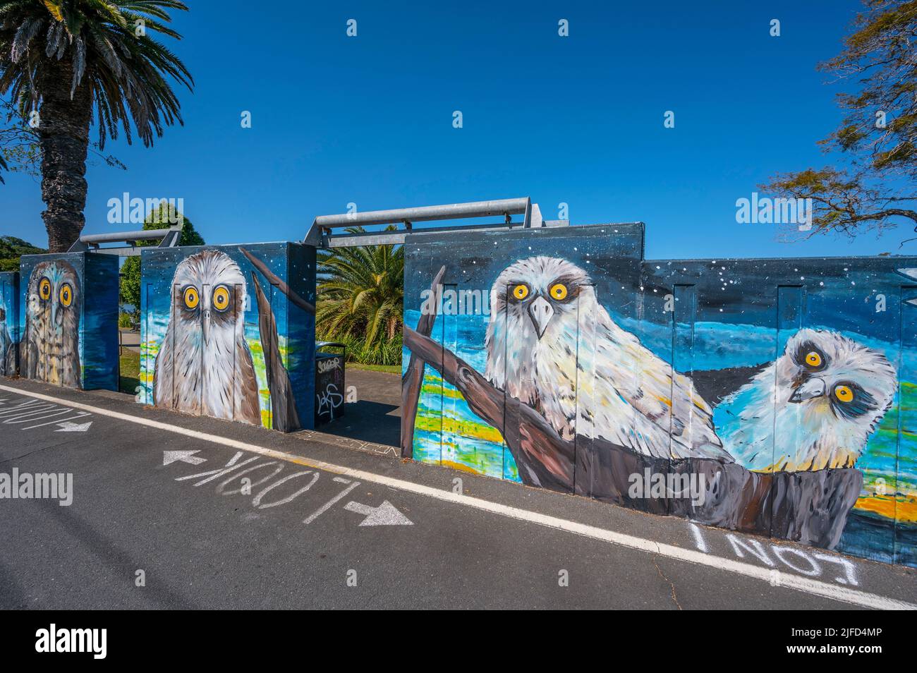 animal and bird and owl mural on concrete flood protection wall in ...