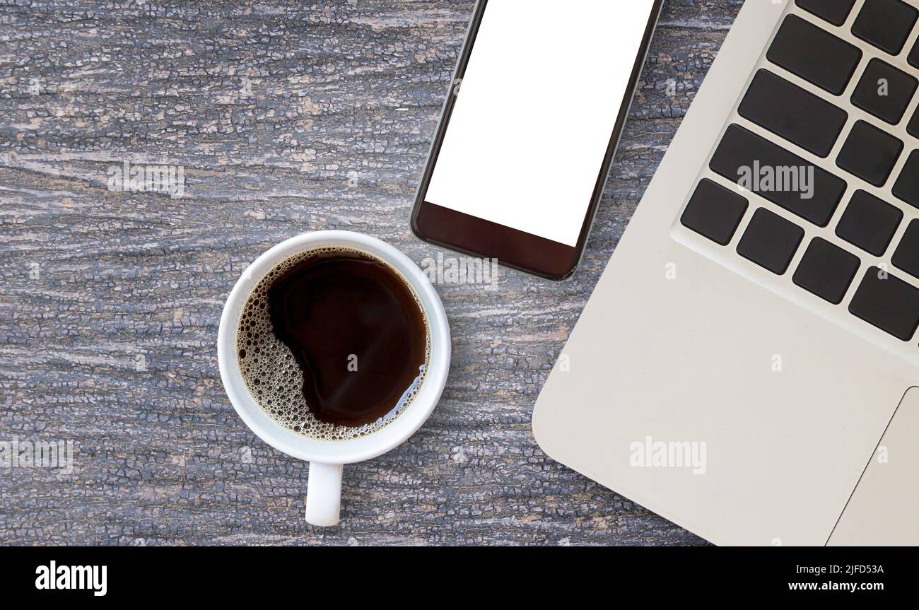 Work desk with laptop computer and hot coffee cup. Top view rustic ...