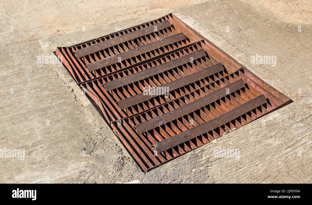 Close up sewer grate on the road Stock Photo - Alamy