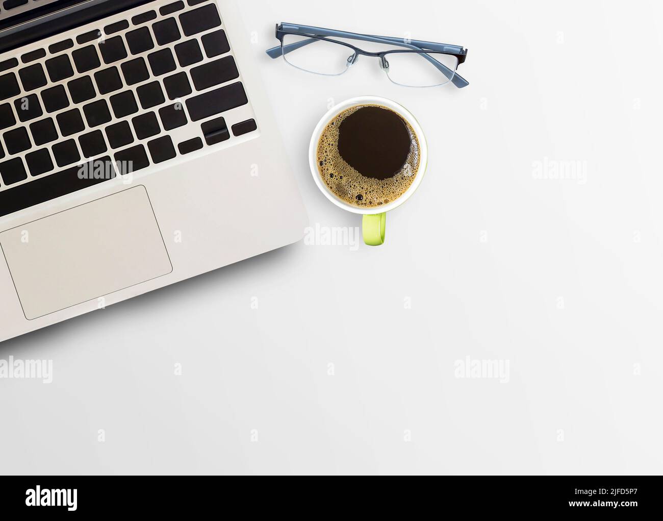 Office desk with cup of coffee and laptop computer on wooden table ...