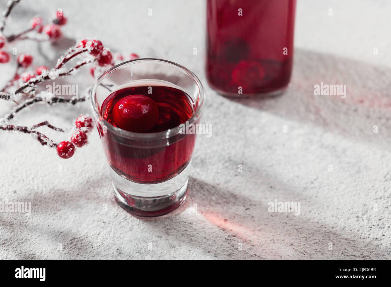 Glass of of cherry liqueur on white background Stock Photo - Alamy
