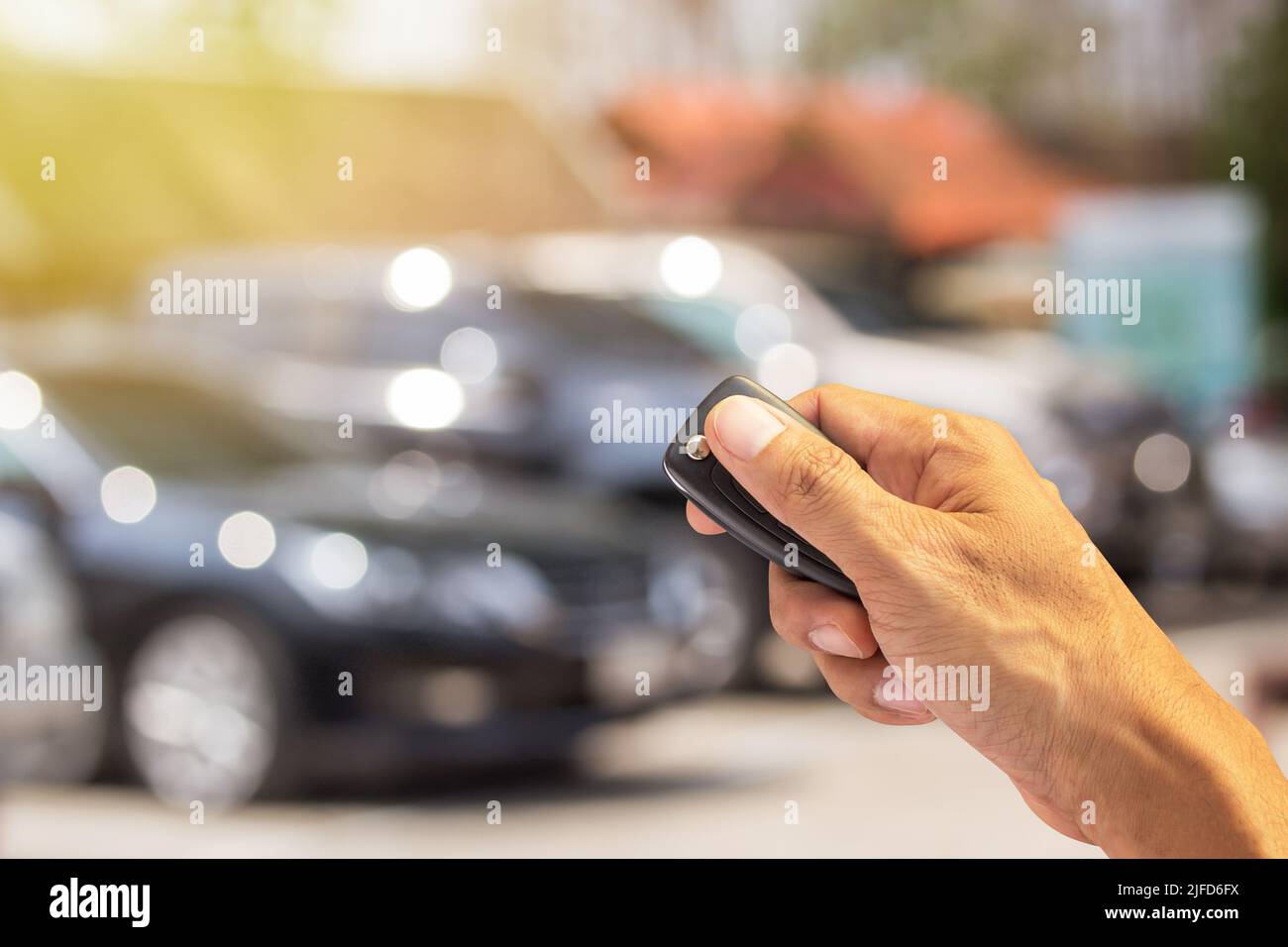 Men's hand presses on the remote control car alarm systems with ...