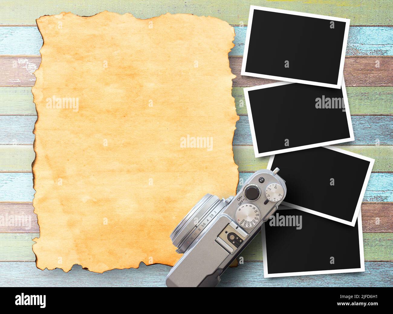 Retro camera and empty old instant paper photo on wood table - blank ...