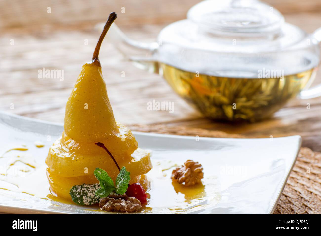 Pear in orange juice with herbal tea Stock Photo - Alamy