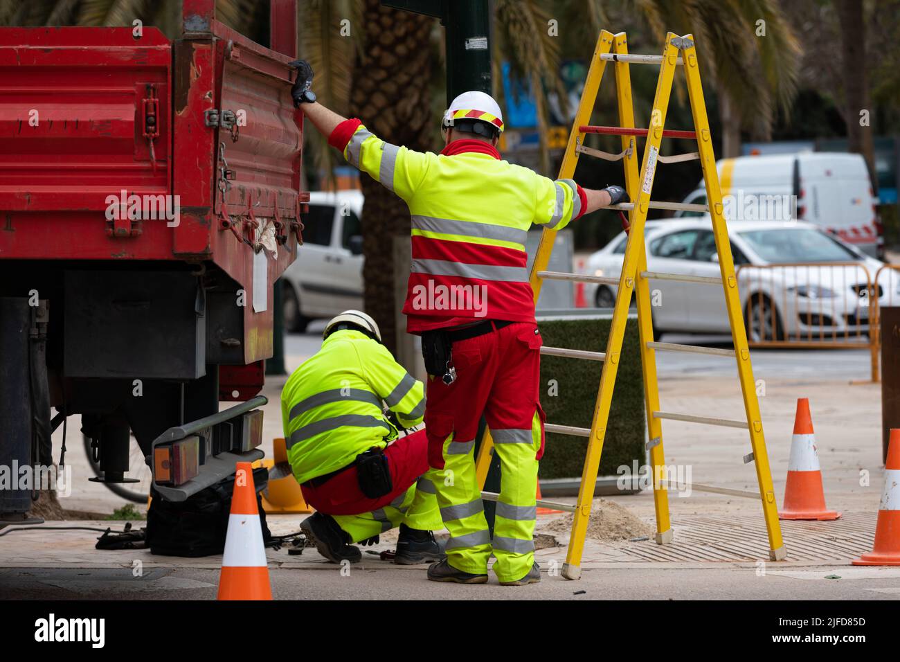 Two electrician worker fixing a traffic light in city street Stock ...