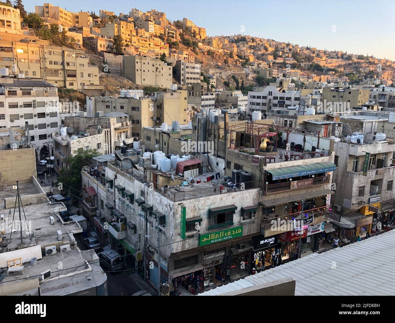 An aerial view of the city of Amman, Jordan on a hill at a golden hour ...