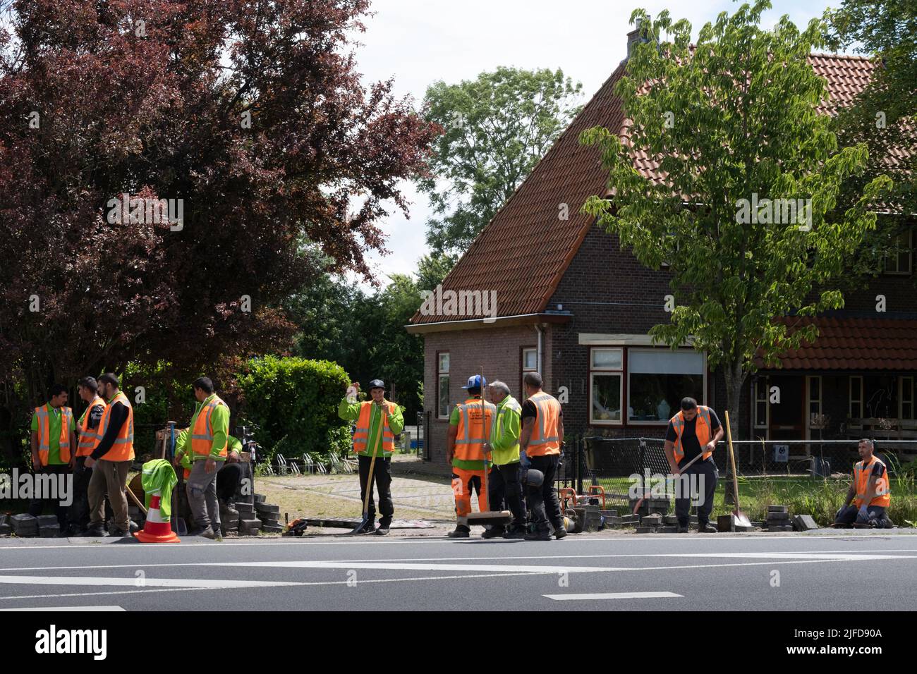 A group of Eastern European workers waits for instructions regarding ...