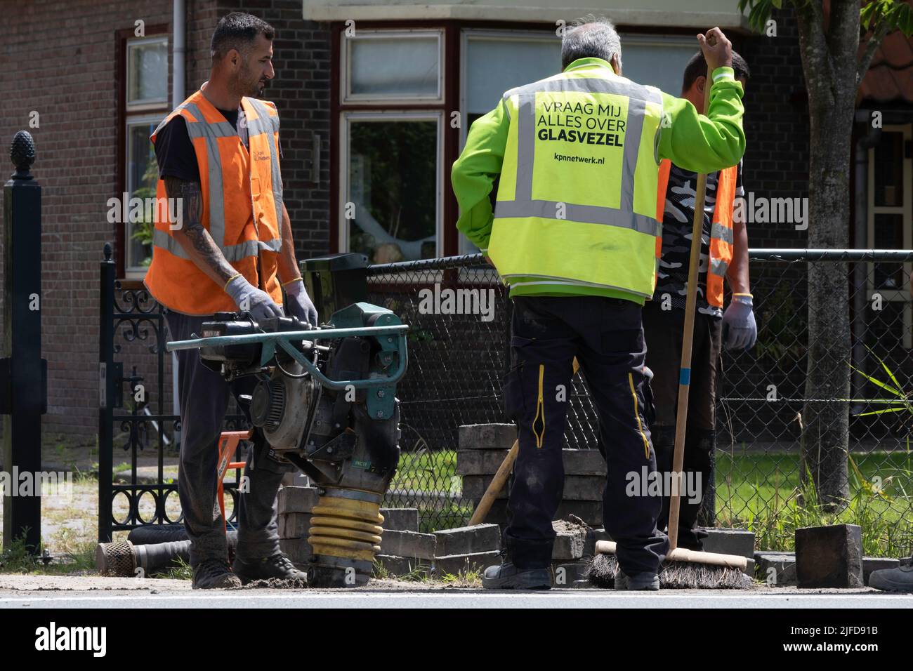 Employees of the Dutch telephone company KPN working with a portable ...