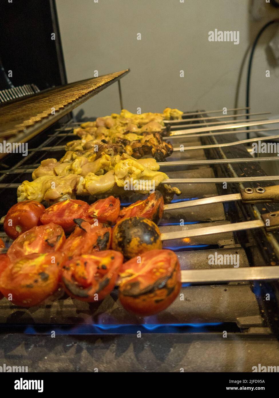 JUDJEH KEBAB grilled chicken skewers and tomato skewers on rice Stock ...