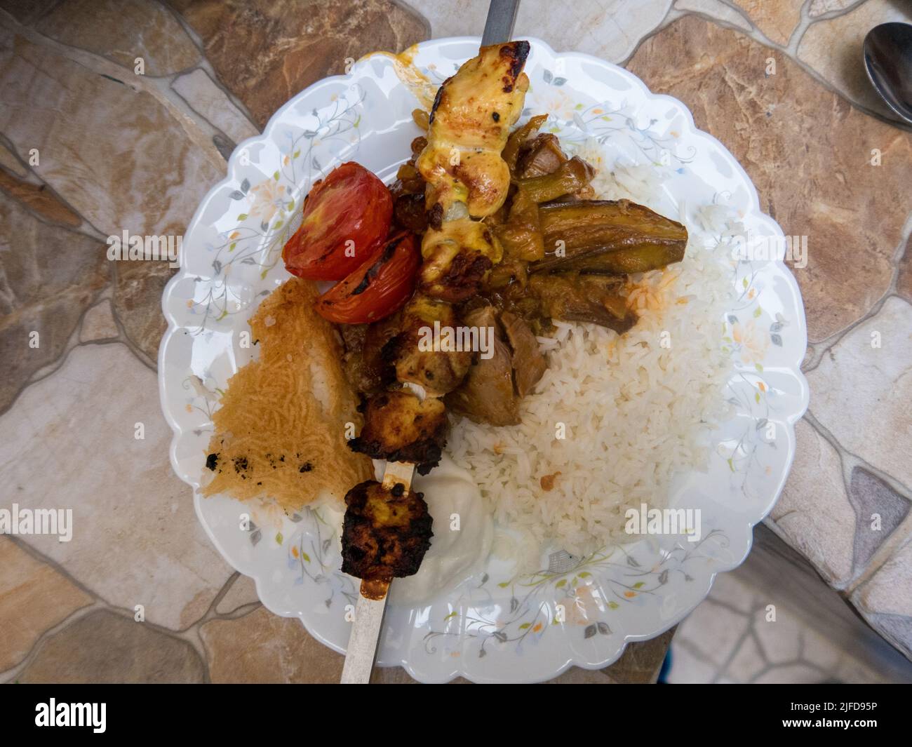 JUDJEH KEBAB grilled chicken skewers and tomato skewers on rice Stock ...